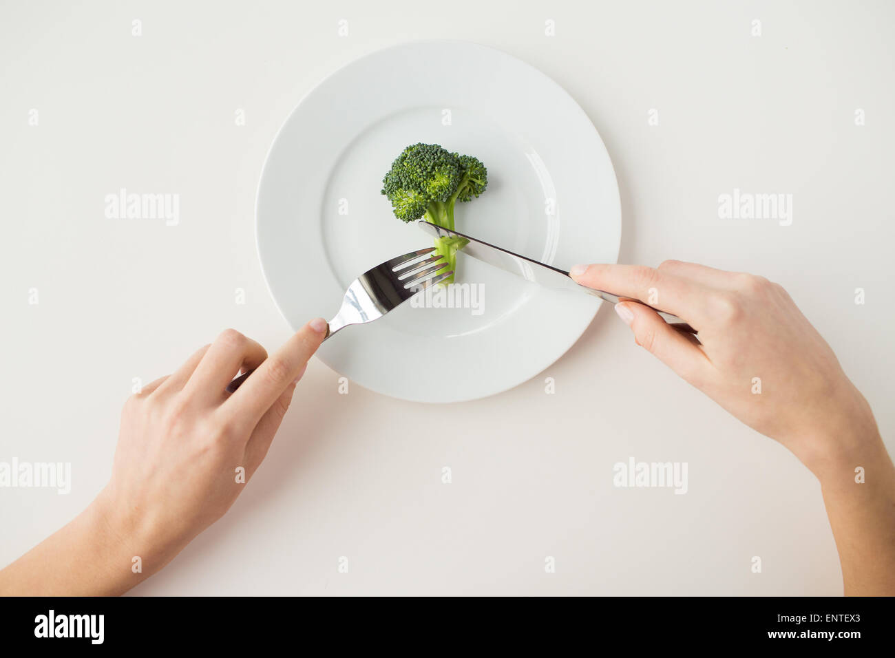 close up of woman hands eating broccoli Stock Photo - Alamy