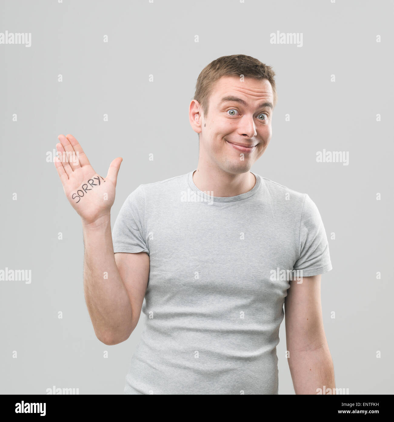 young caucasian man showing message written on his hand and smiling ...