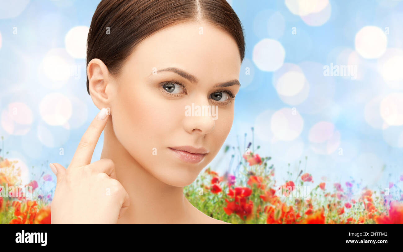face of beautiful woman touching her ear Stock Photo - Alamy