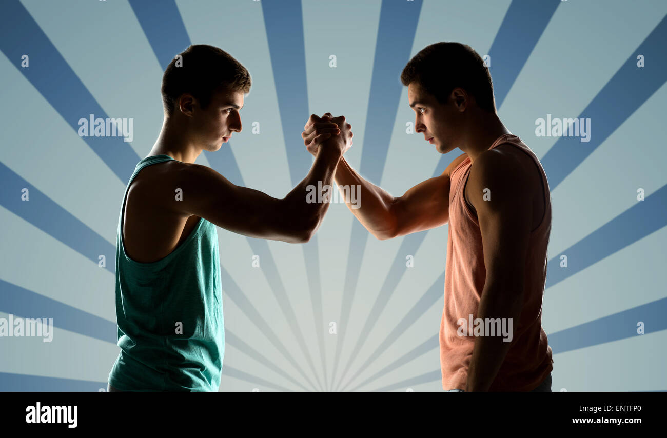 Young men arm wrestling hi-res stock photography and images - Alamy