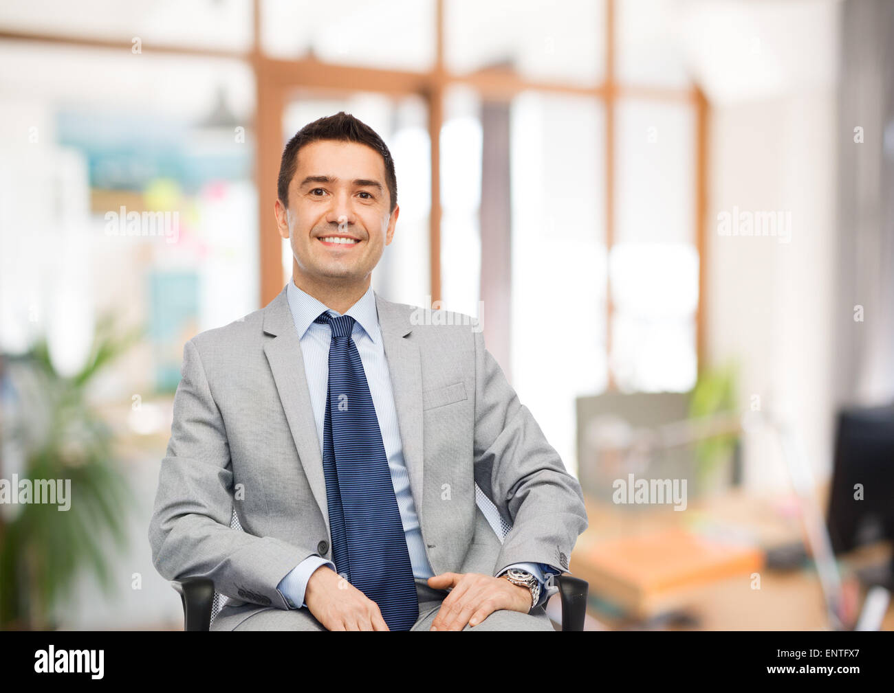 happy businessman sitting in office chair Stock Photo - Alamy