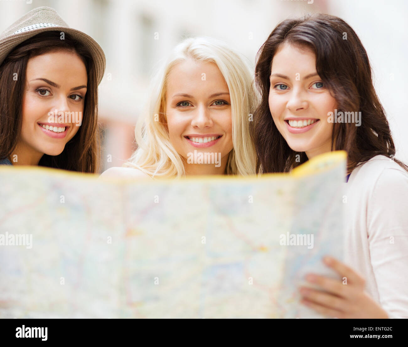 beautiful girls with map in the city Stock Photo - Alamy