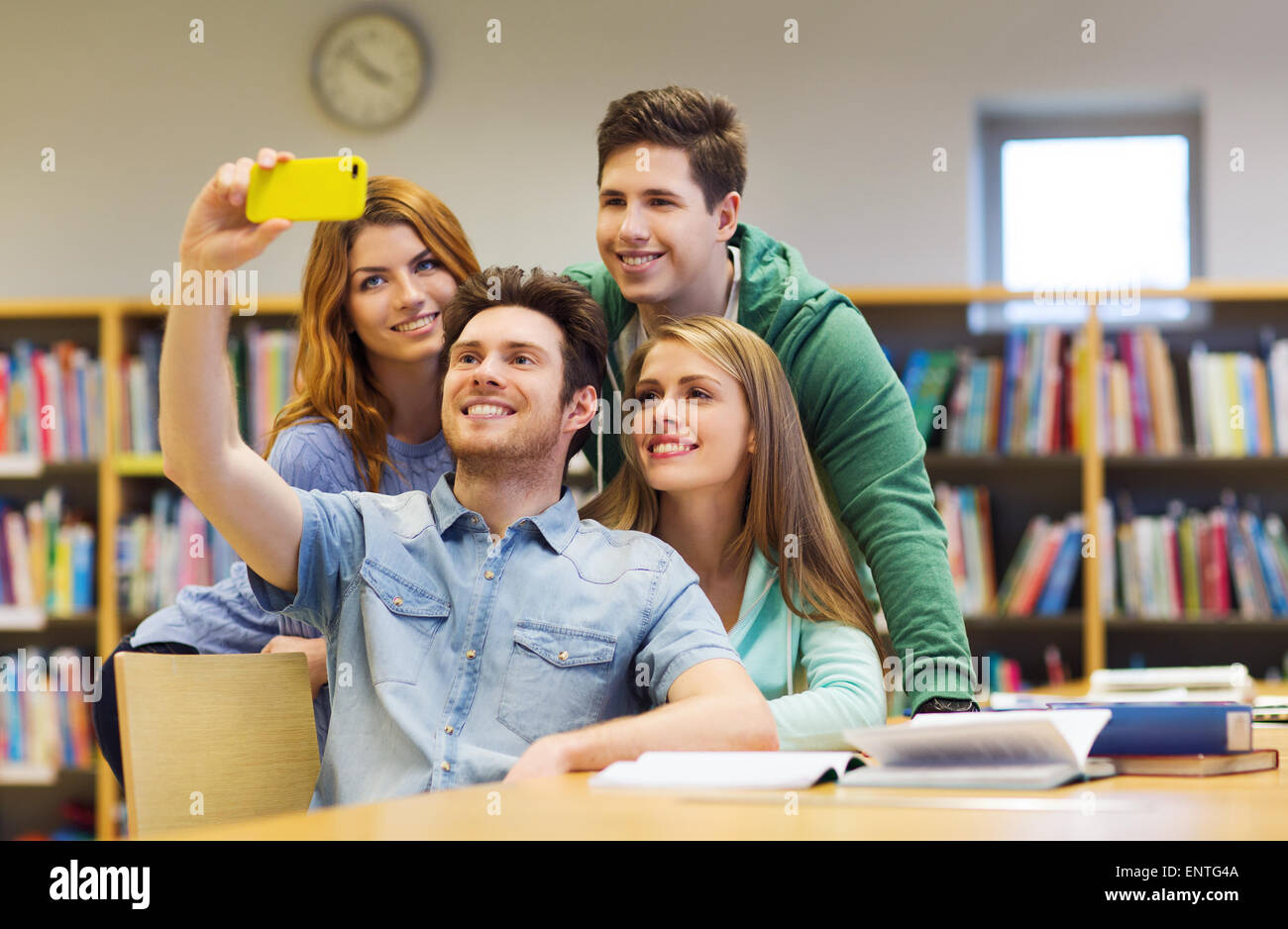 students with smartphone taking selfie in library Stock Photo - Alamy