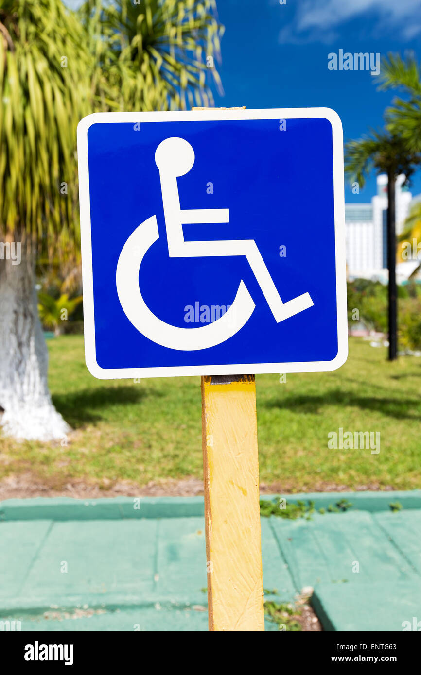 Blue handicapped sign with wheelchair, outdoors Stock Photo - Alamy