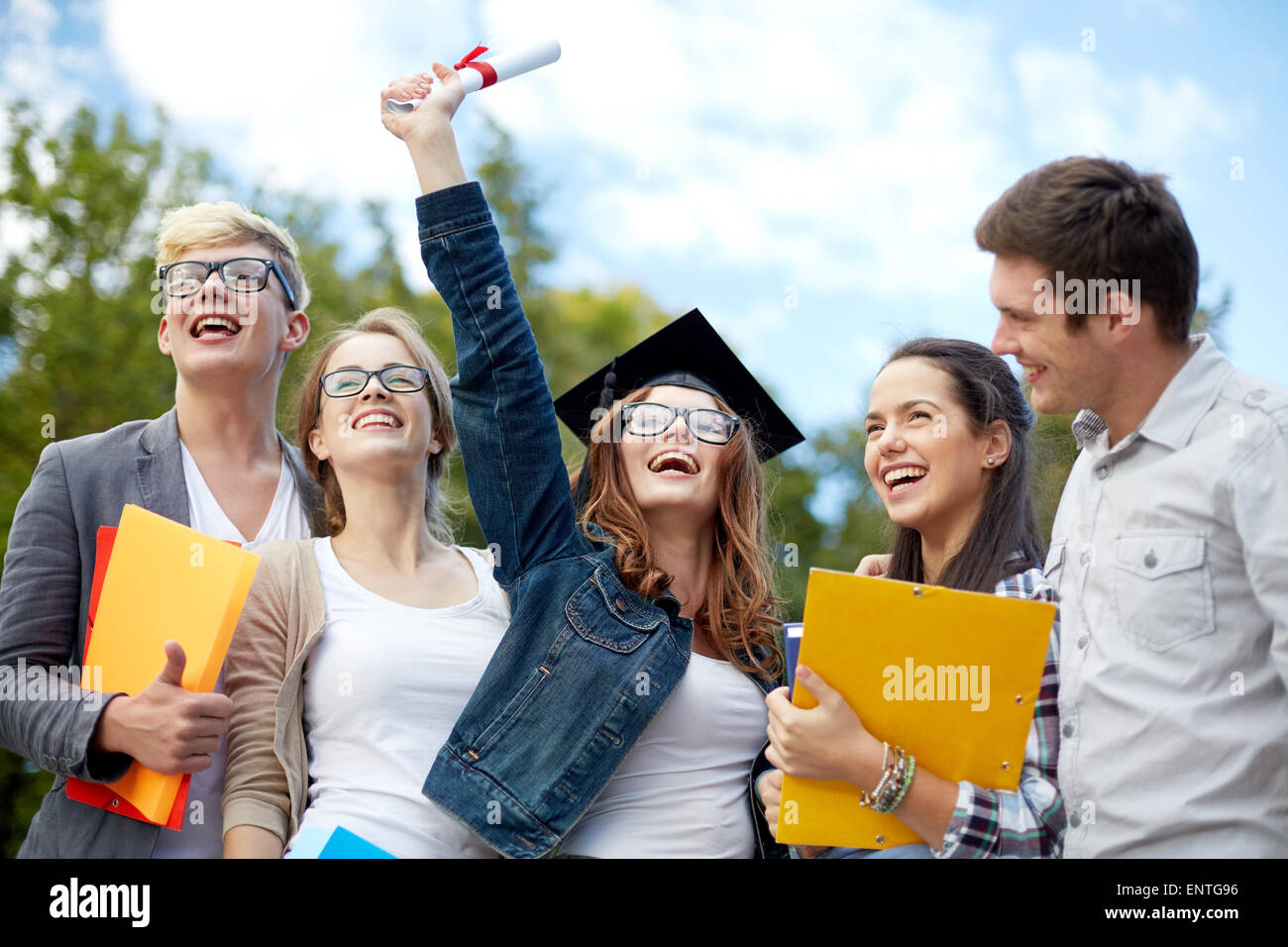 group of smiling students with diploma and folders Stock Photo - Alamy