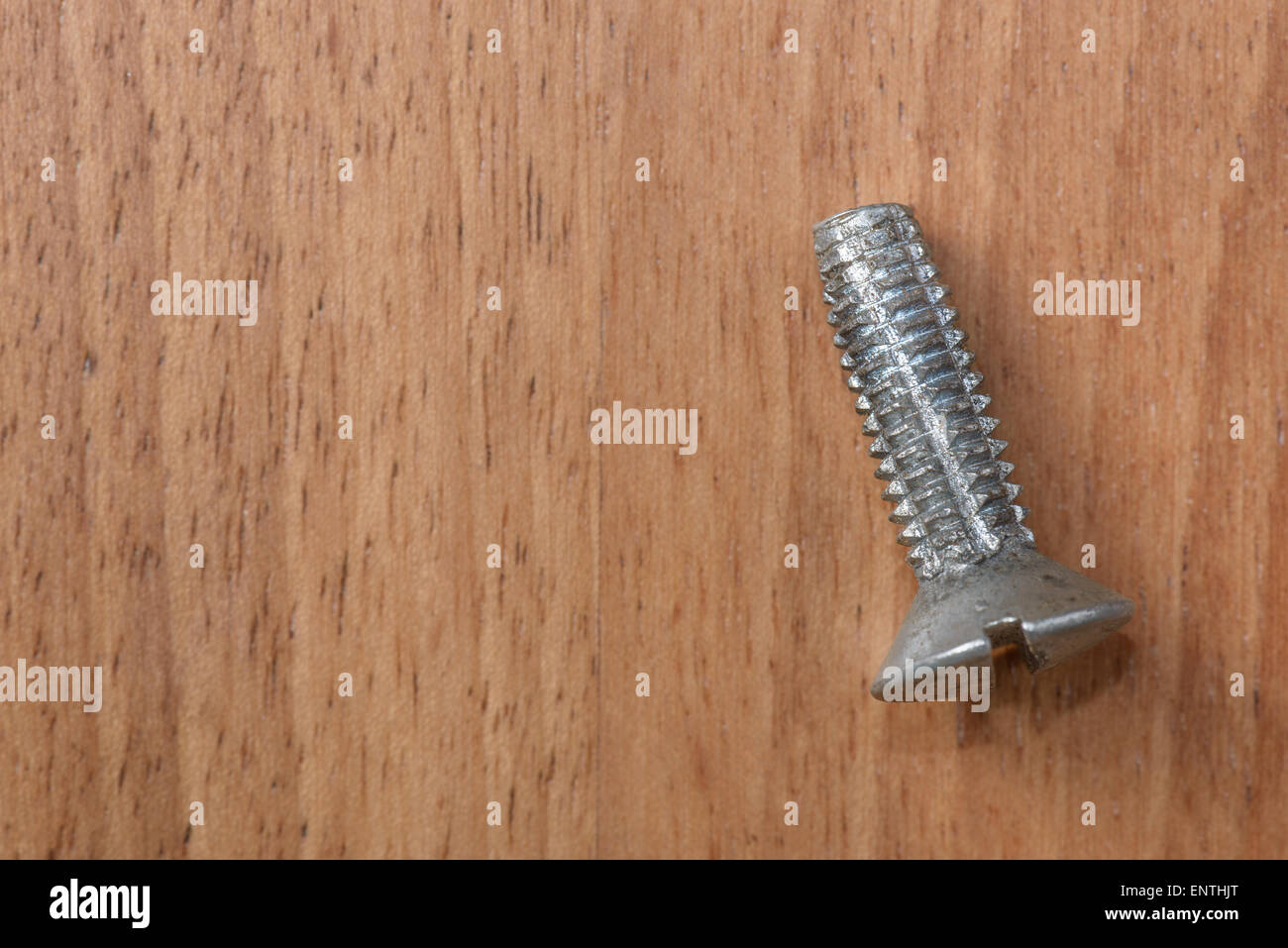One bolt on wood blur background Stock Photo - Alamy