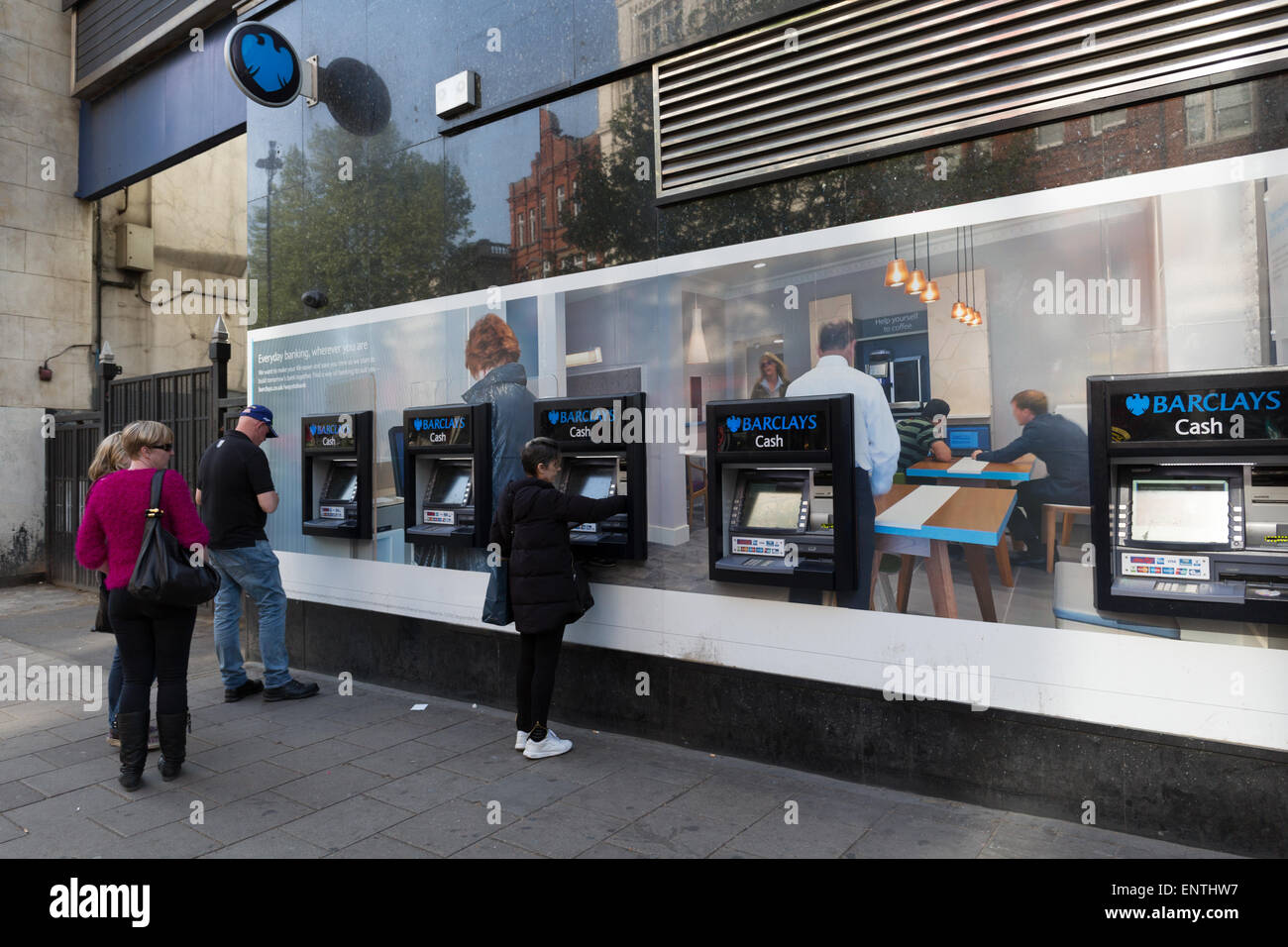Customers queing at a Barclays bank ATM machine in Central London UK ...