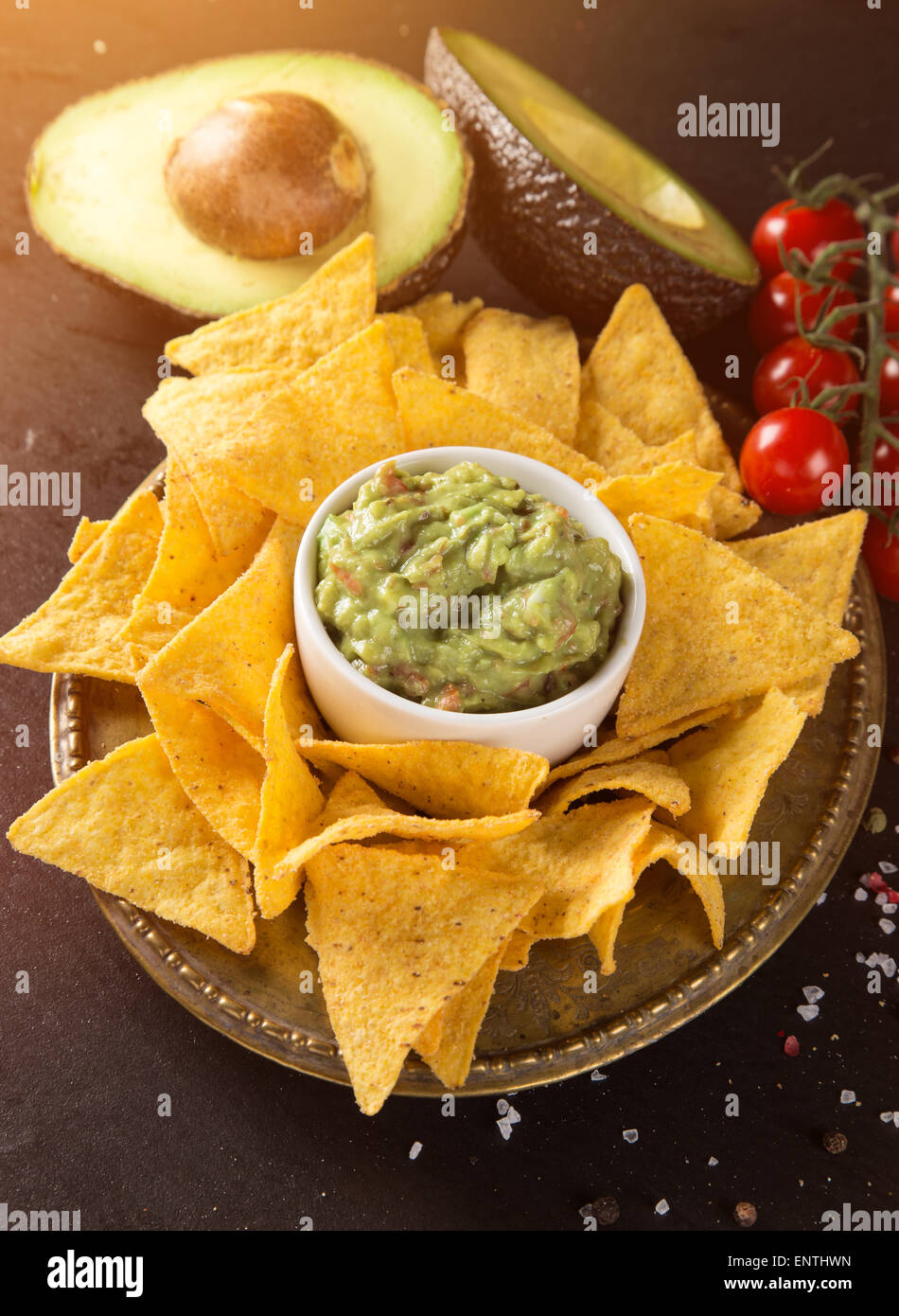 Green Guacamole with nachos and avocado on stone background Stock Photo ...