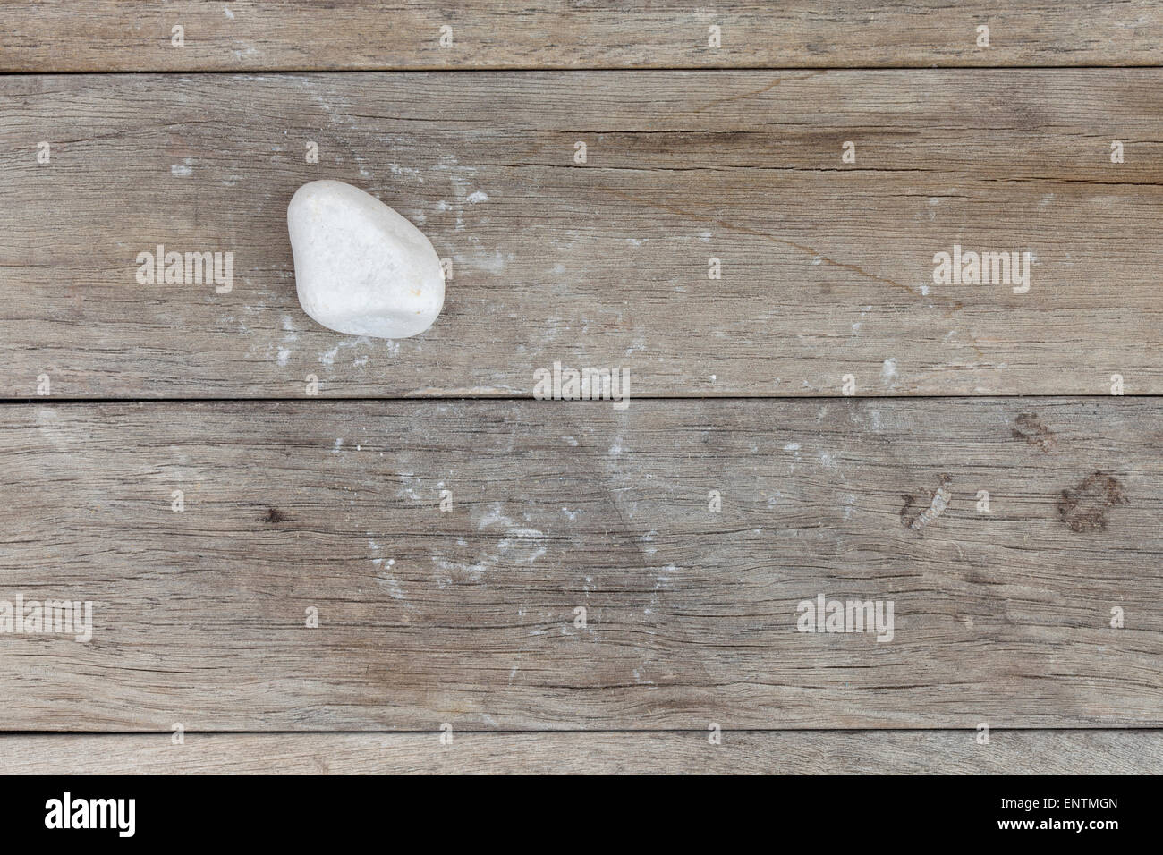 background with a white stone on a wooden surface Stock Photo - Alamy
