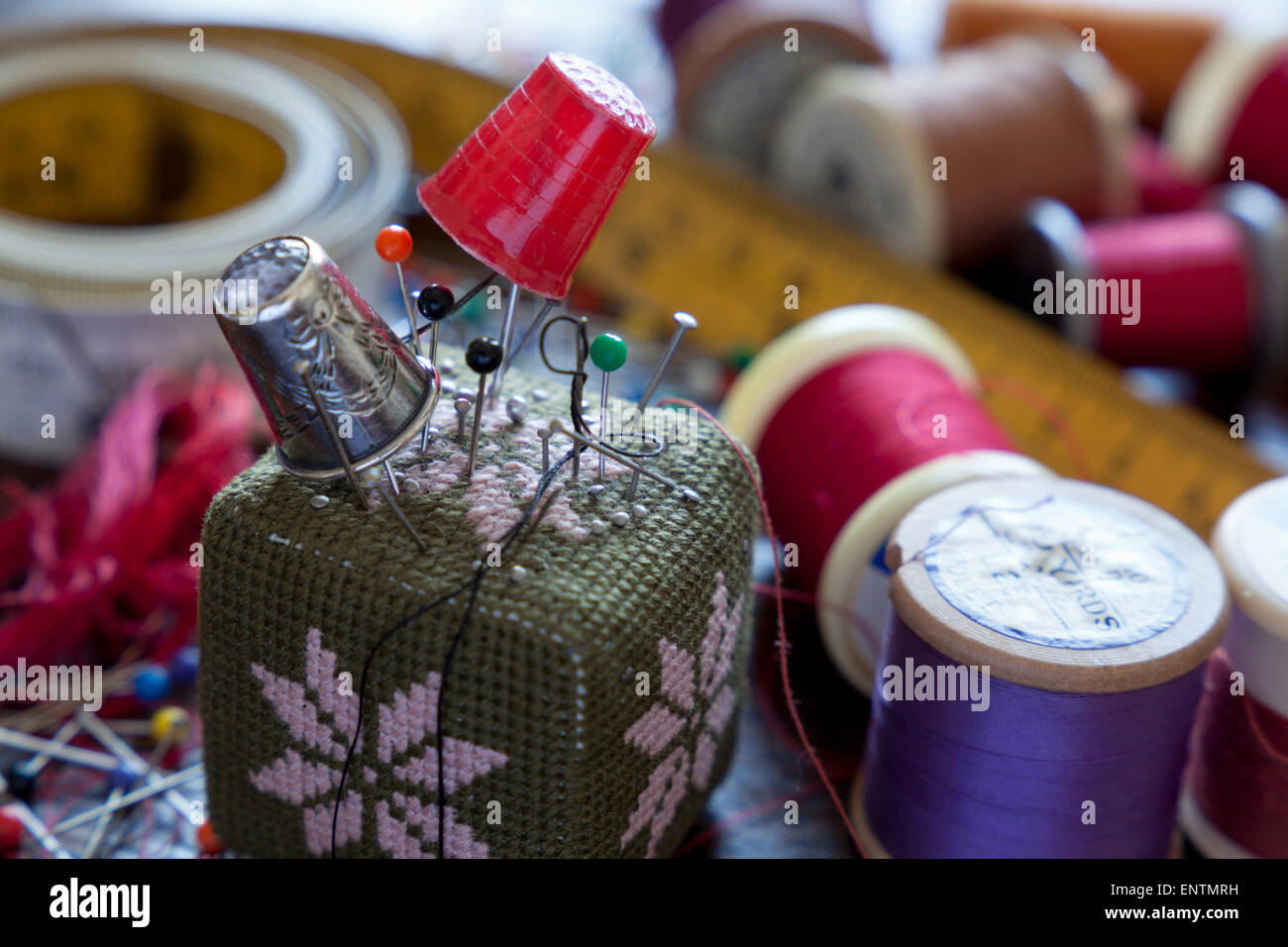 Pincushion with pins and cotton reels Stock Photo - Alamy