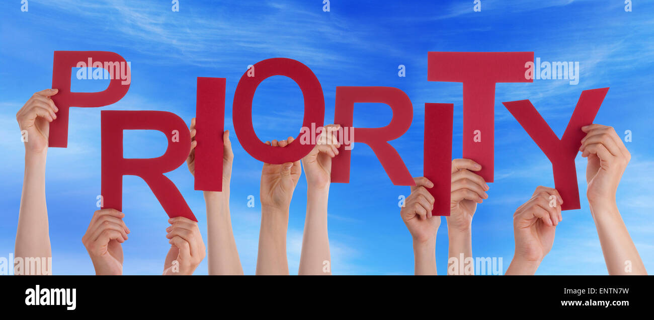 People Hands Holding Red Word Priority Blue Sky Stock Photo - Alamy
