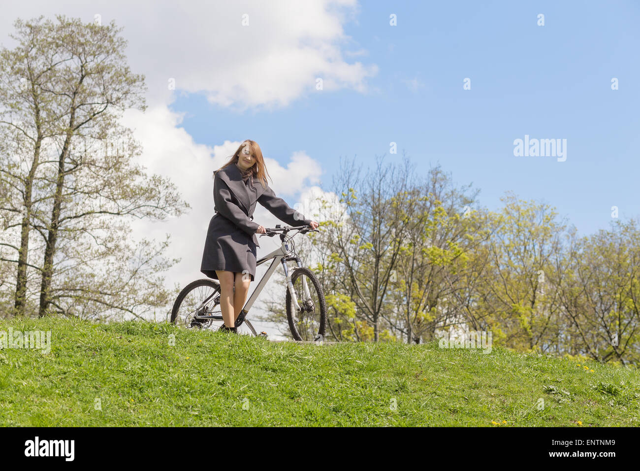 pretty girl with bike walks in park Stock Photo - Alamy
