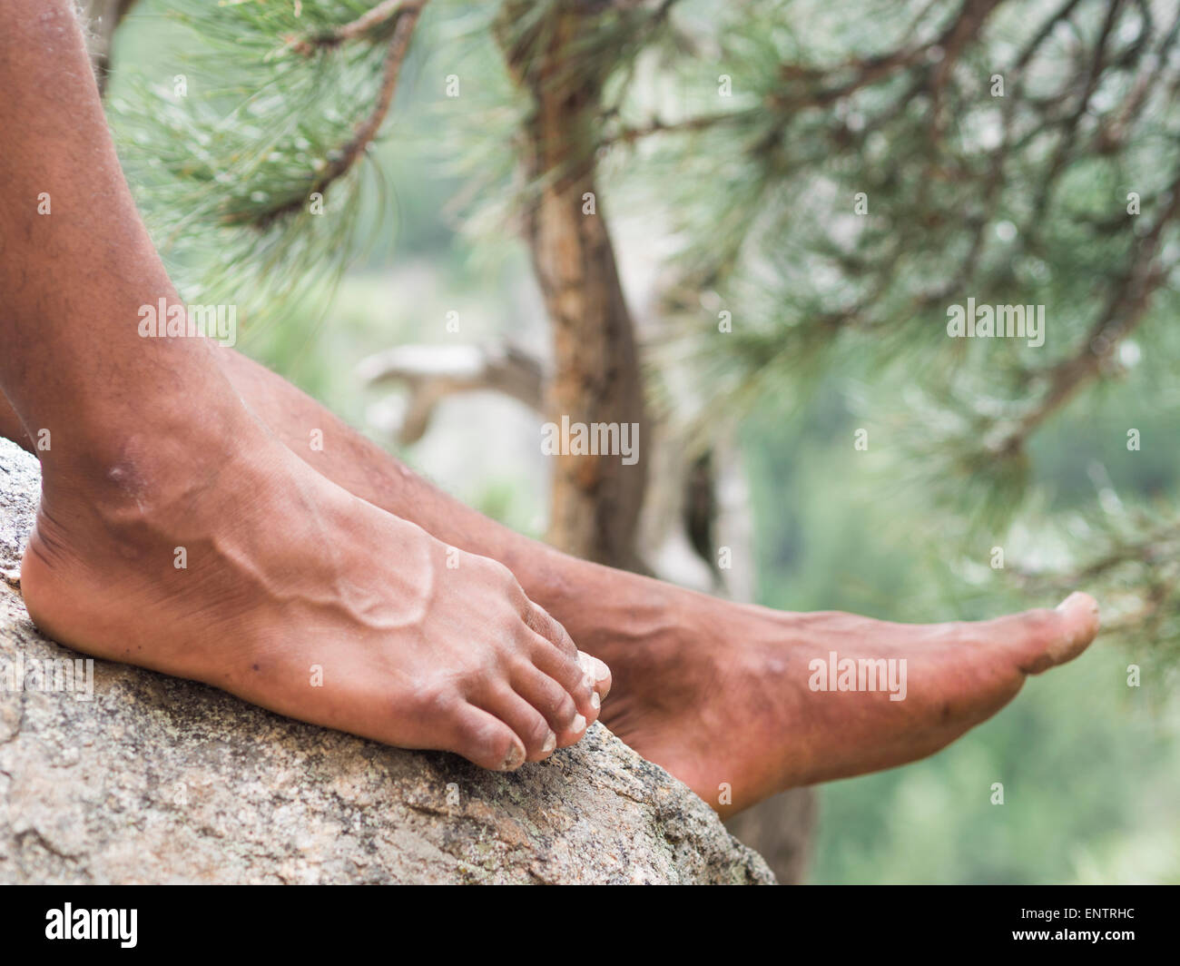 A man relaxes barefoot after a rock climb at Sports Park in Boulder ...