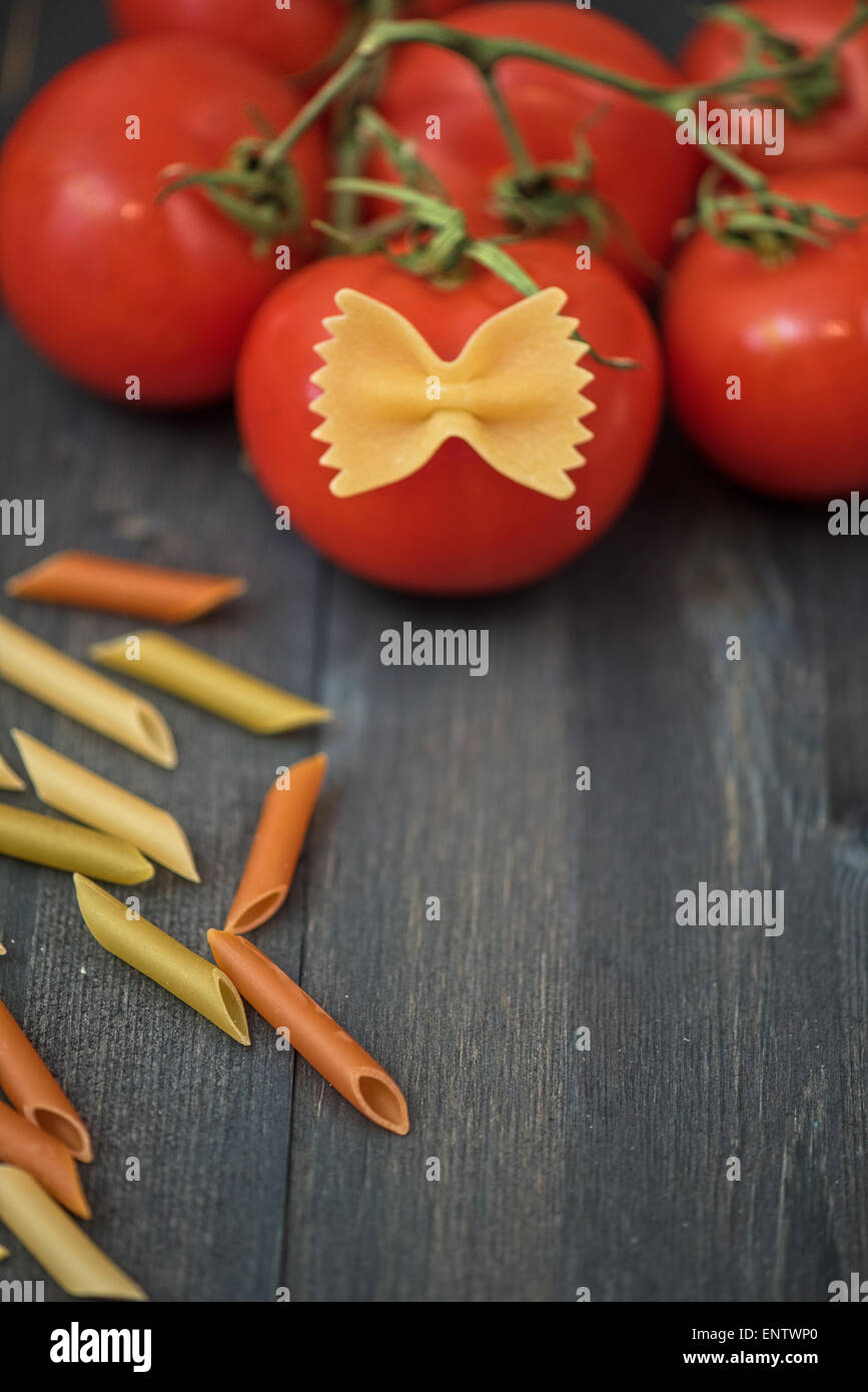 food background on rustic wood with pasta and tomatoes Stock Photo - Alamy