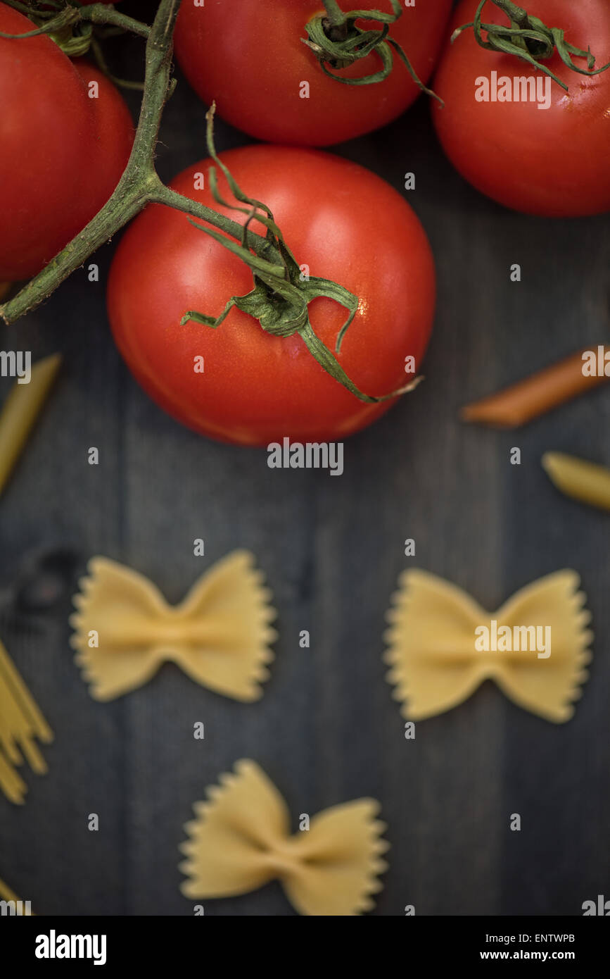 food background on rustic wood with pasta and tomatoes Stock Photo - Alamy