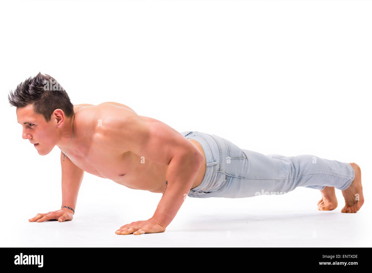Handsome shirtless bodybuilder doing push-ups in studio shot, isolated ...