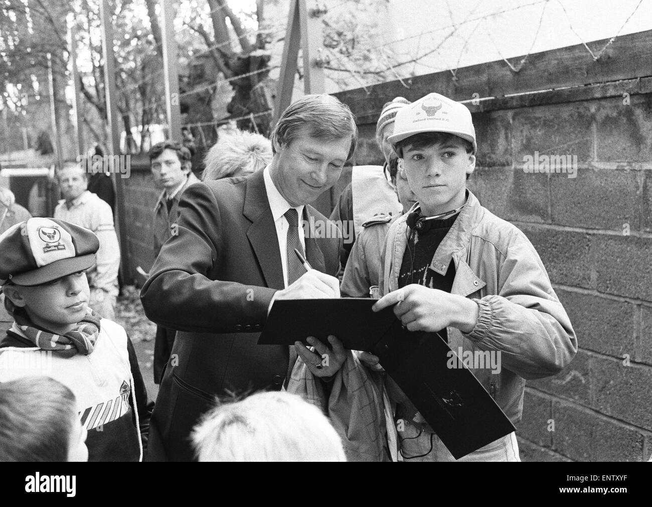 New Manchester United manager Alex Ferguson signs autographs for young ...
