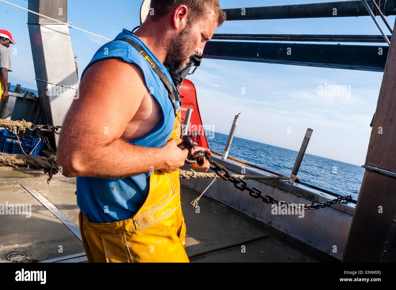 Fishermen working on trawler Stock Photo - Alamy