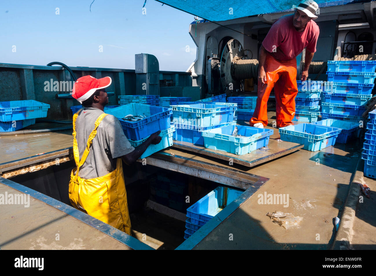 Fishermen working on trawler Stock Photo - Alamy