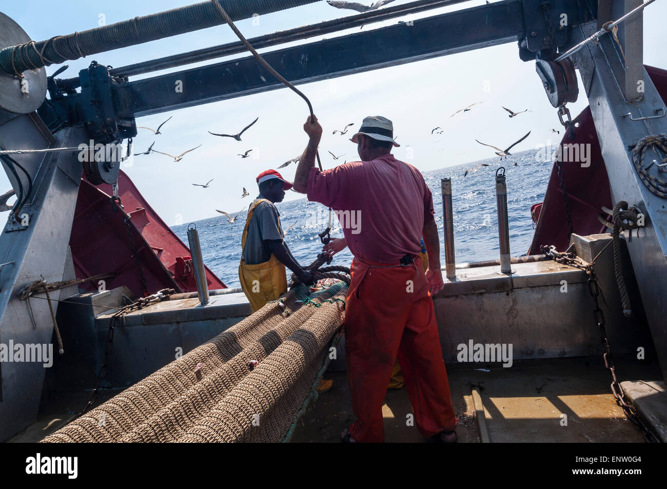 Fishermen working on trawler Stock Photo - Alamy