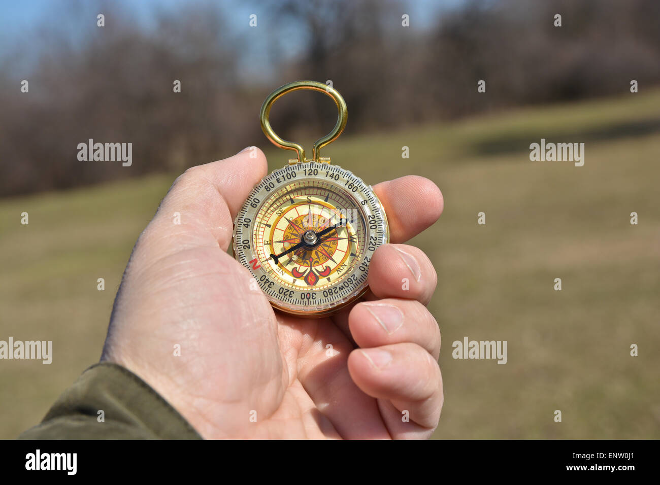 Compass orientation. Magnetic compass in the hand on the background of ...