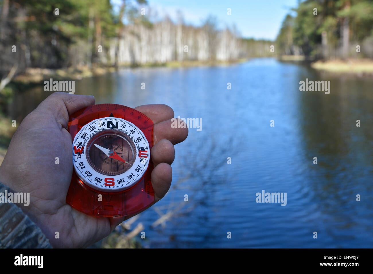 With compass on spring river. Magnetic compass in the hand on the ...