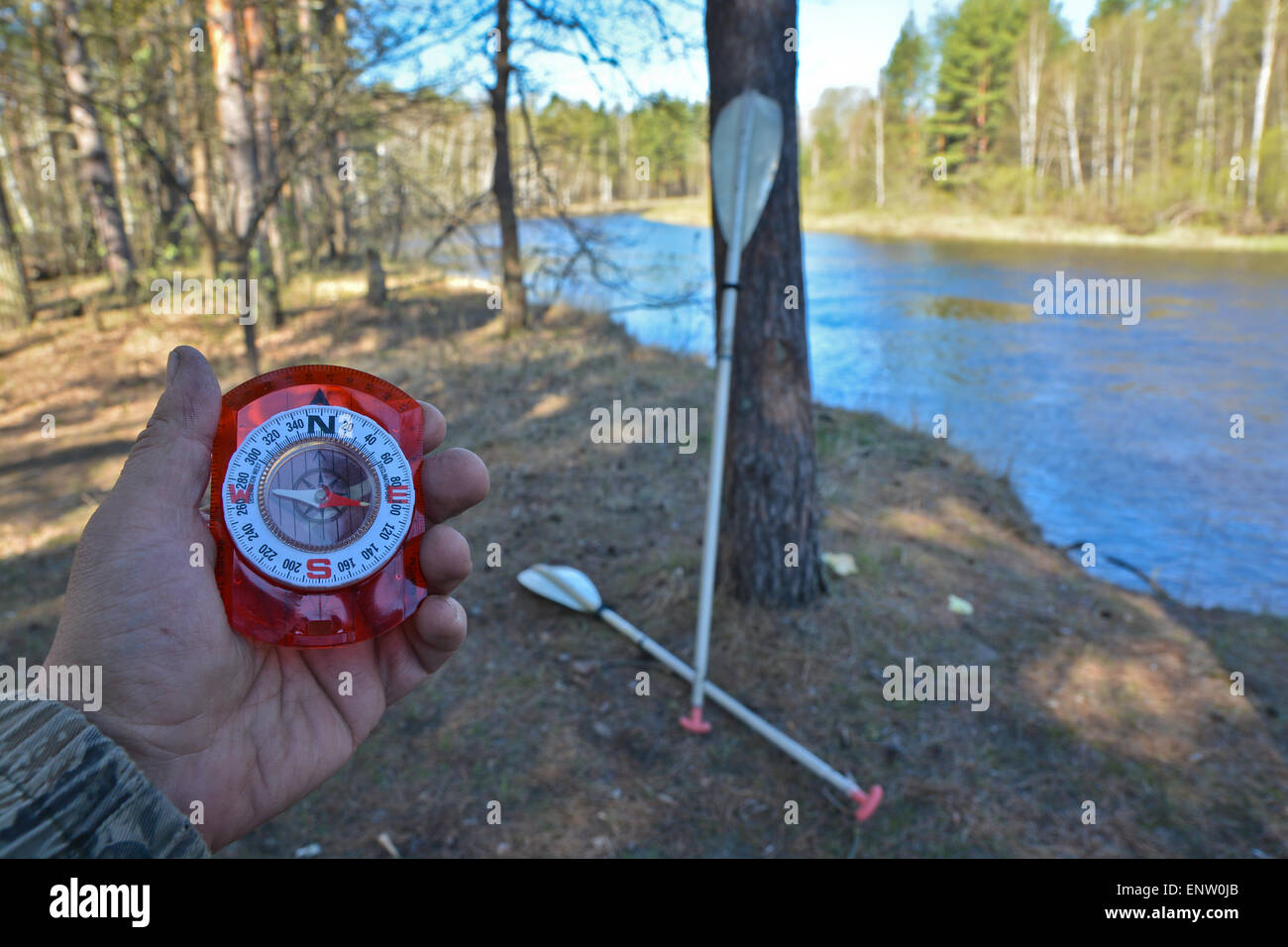 With compass on spring river. Magnetic compass in the hand on the ...