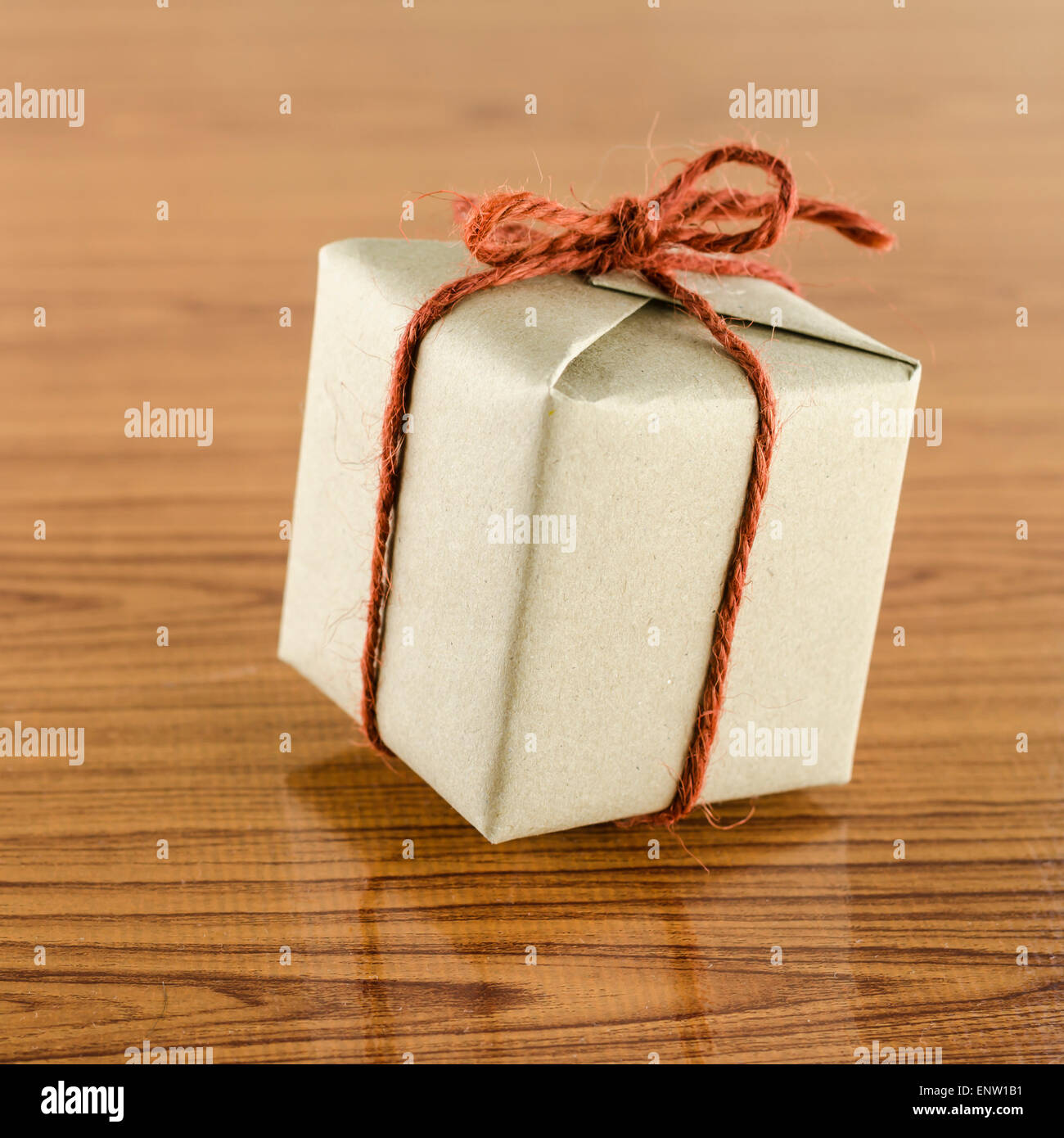 brown gift box on wooden background Stock Photo - Alamy