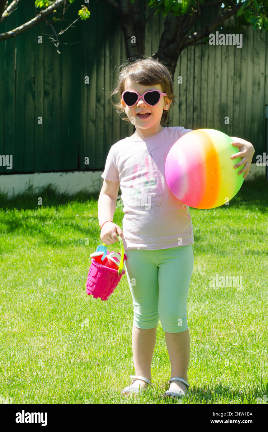 Child carrying ball hi-res stock photography and images - Alamy