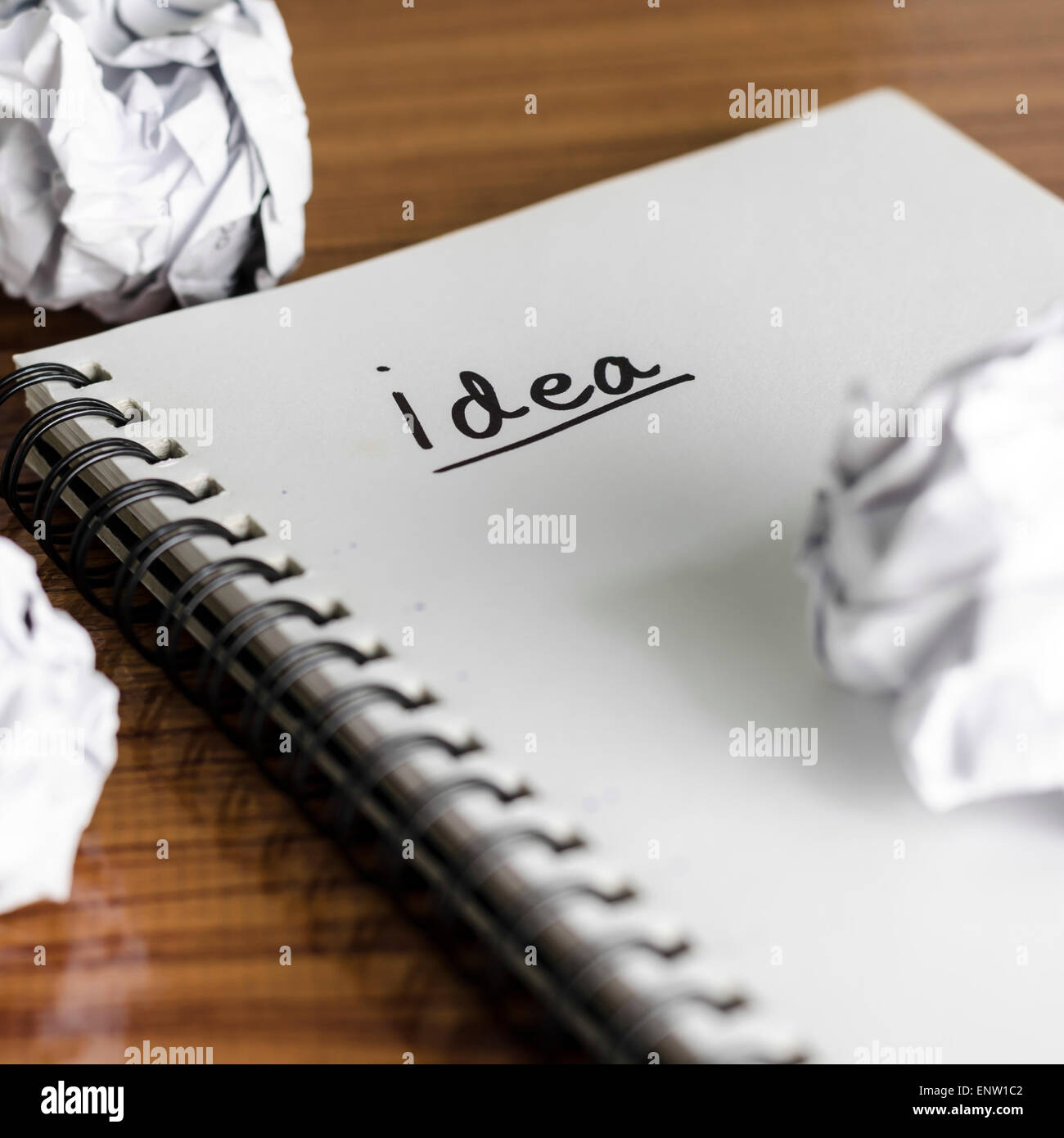 notebook write idea word with crumpled on wooden background Stock Photo ...