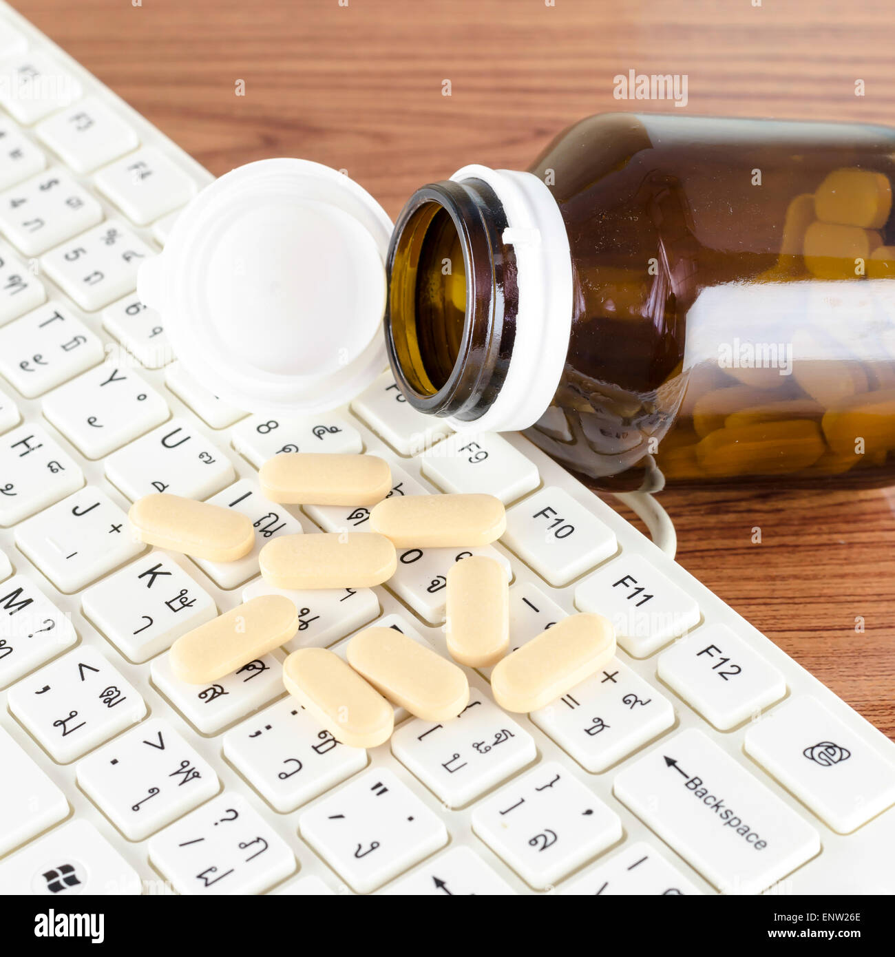 pills on keyboard computer on wooden background concept technology ...