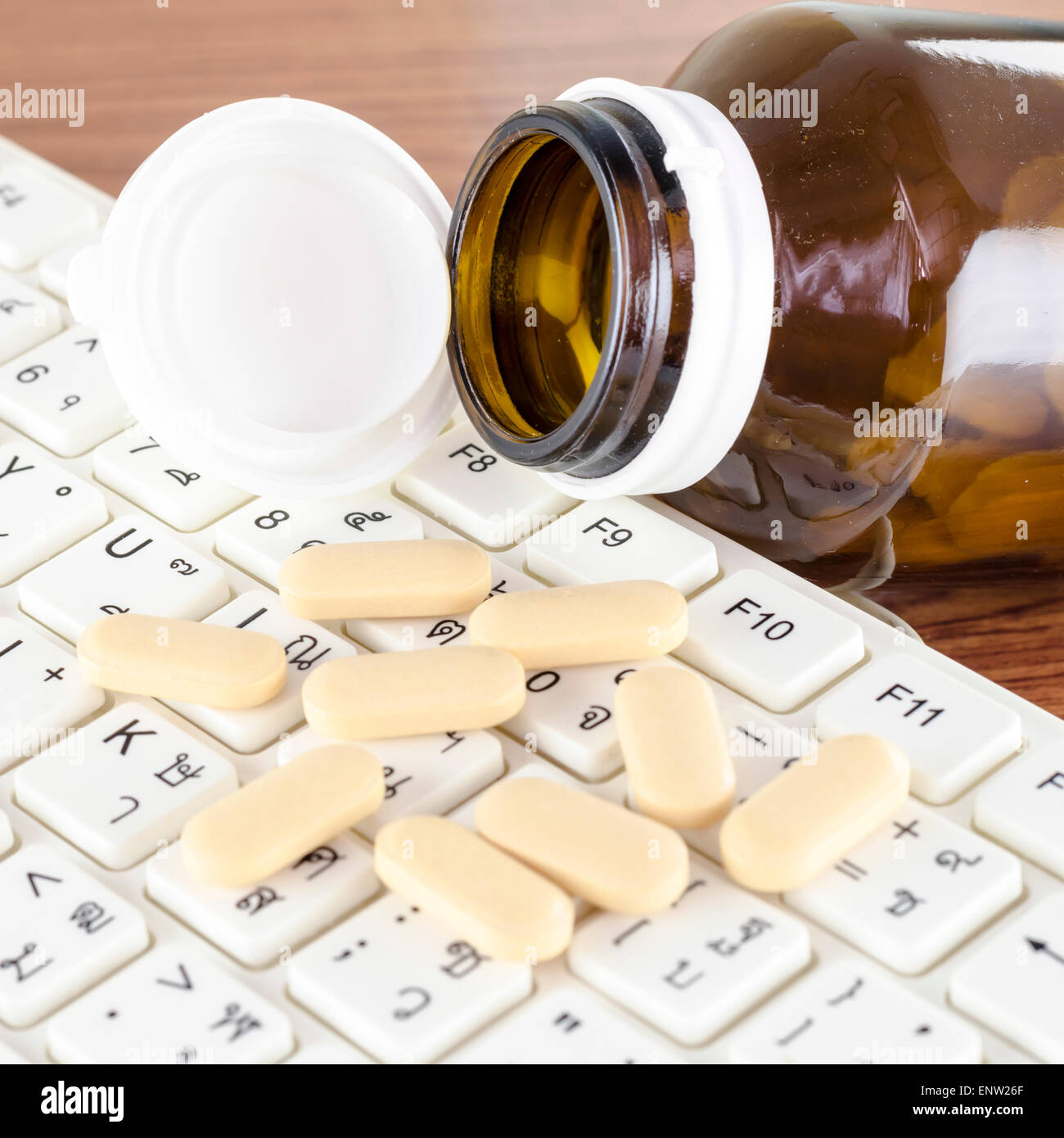pills on keyboard computer on wooden background concept technology ...