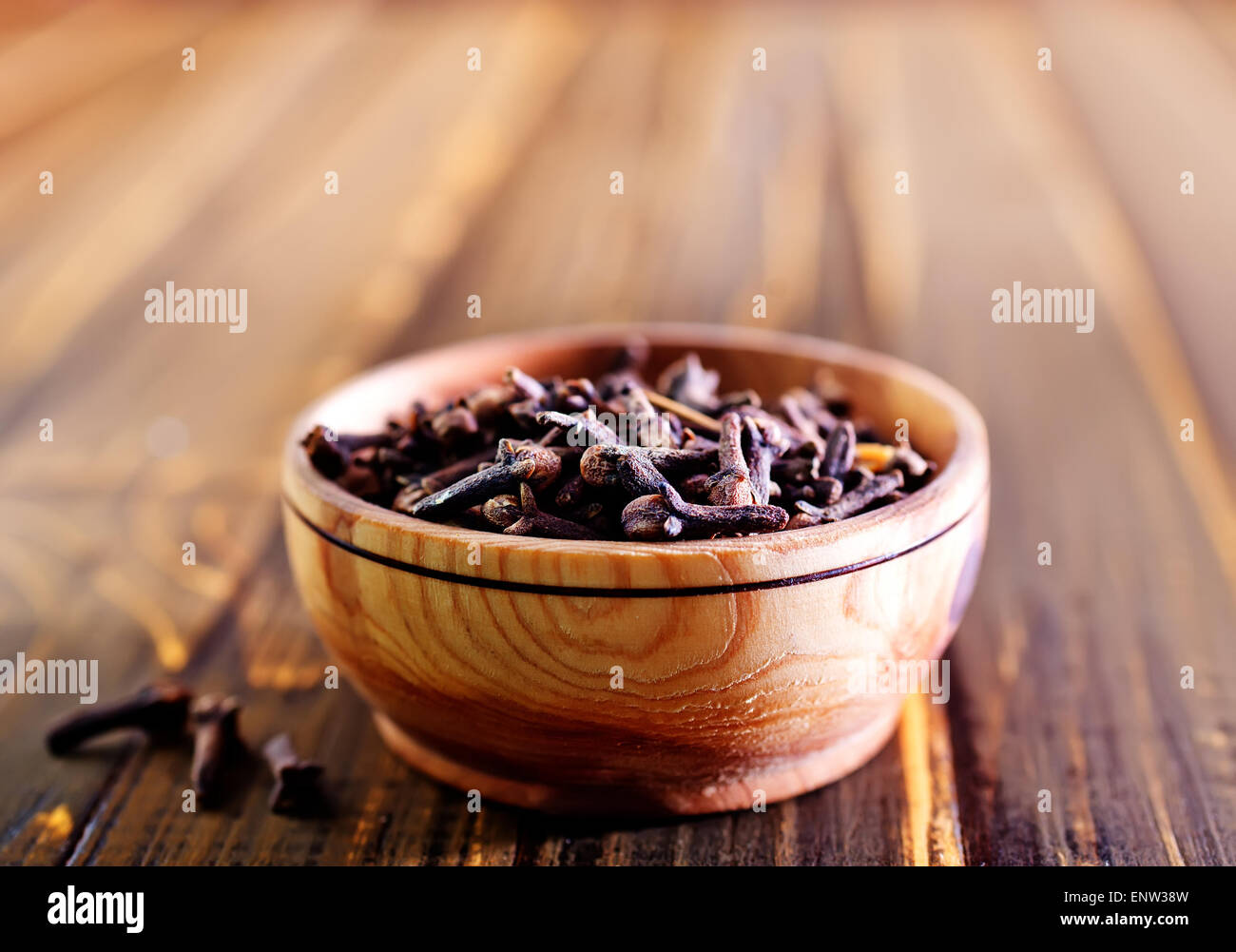 cloves in wooden bowl and on a table Stock Photo - Alamy