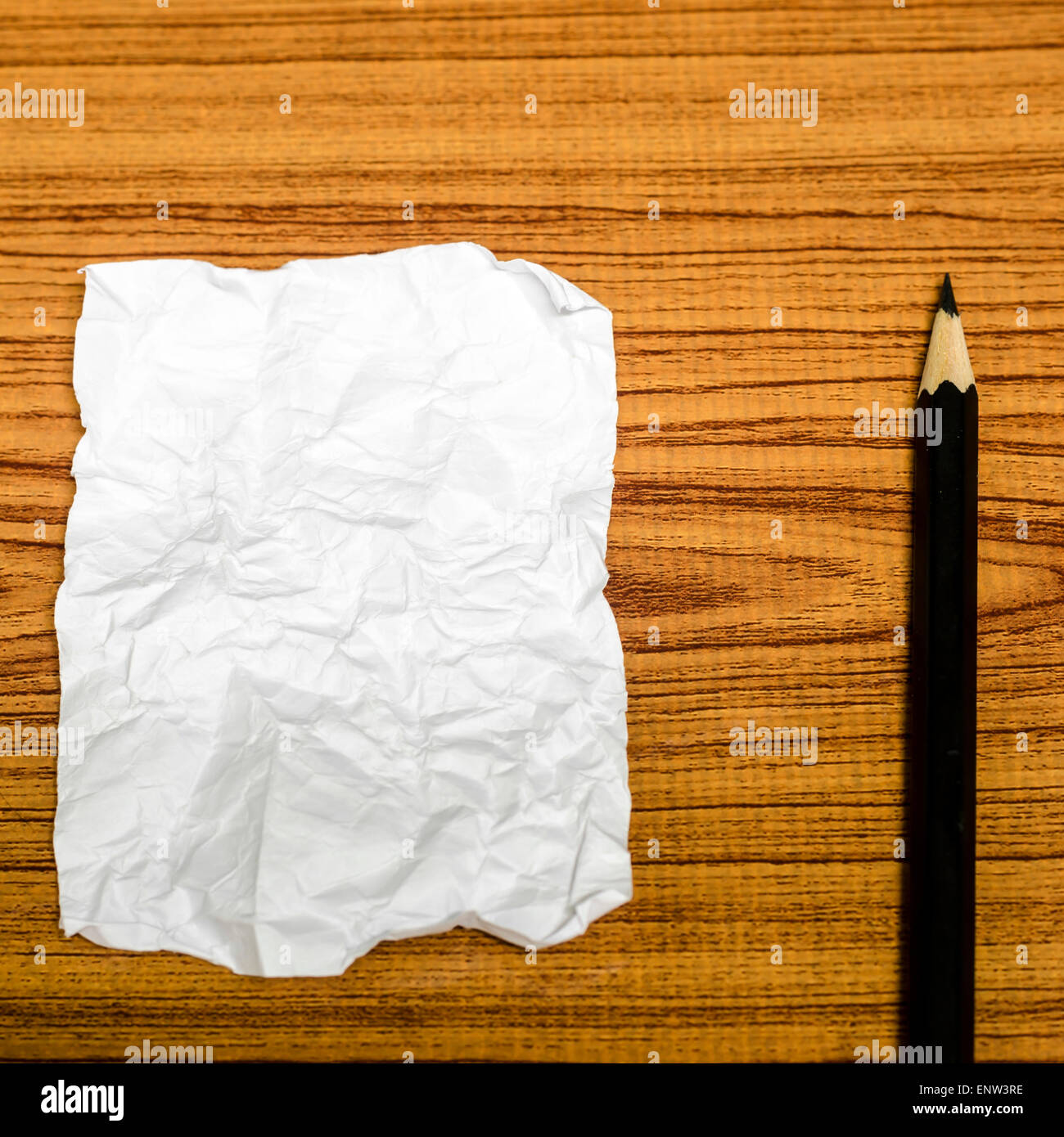 paper scrap with pencil on wood background Stock Photo - Alamy