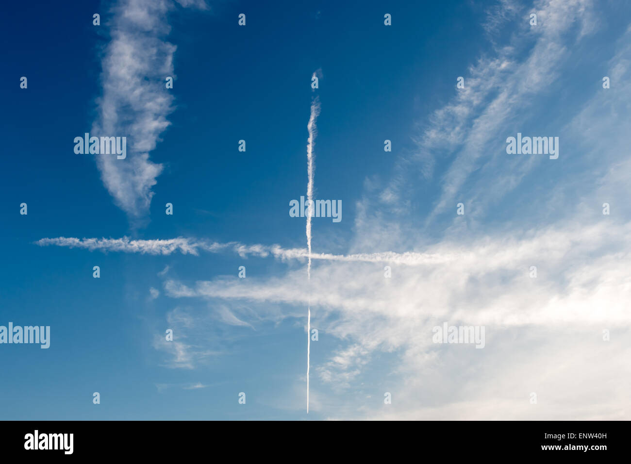 Bottom view of two aircraft tracks in deep blue sky with clouds.Concept ...