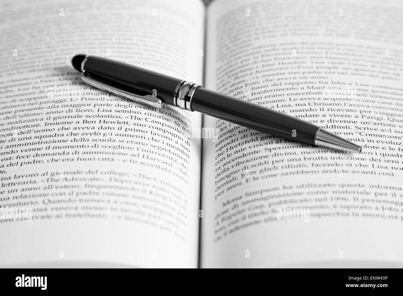 a pen resting on an open book Stock Photo - Alamy