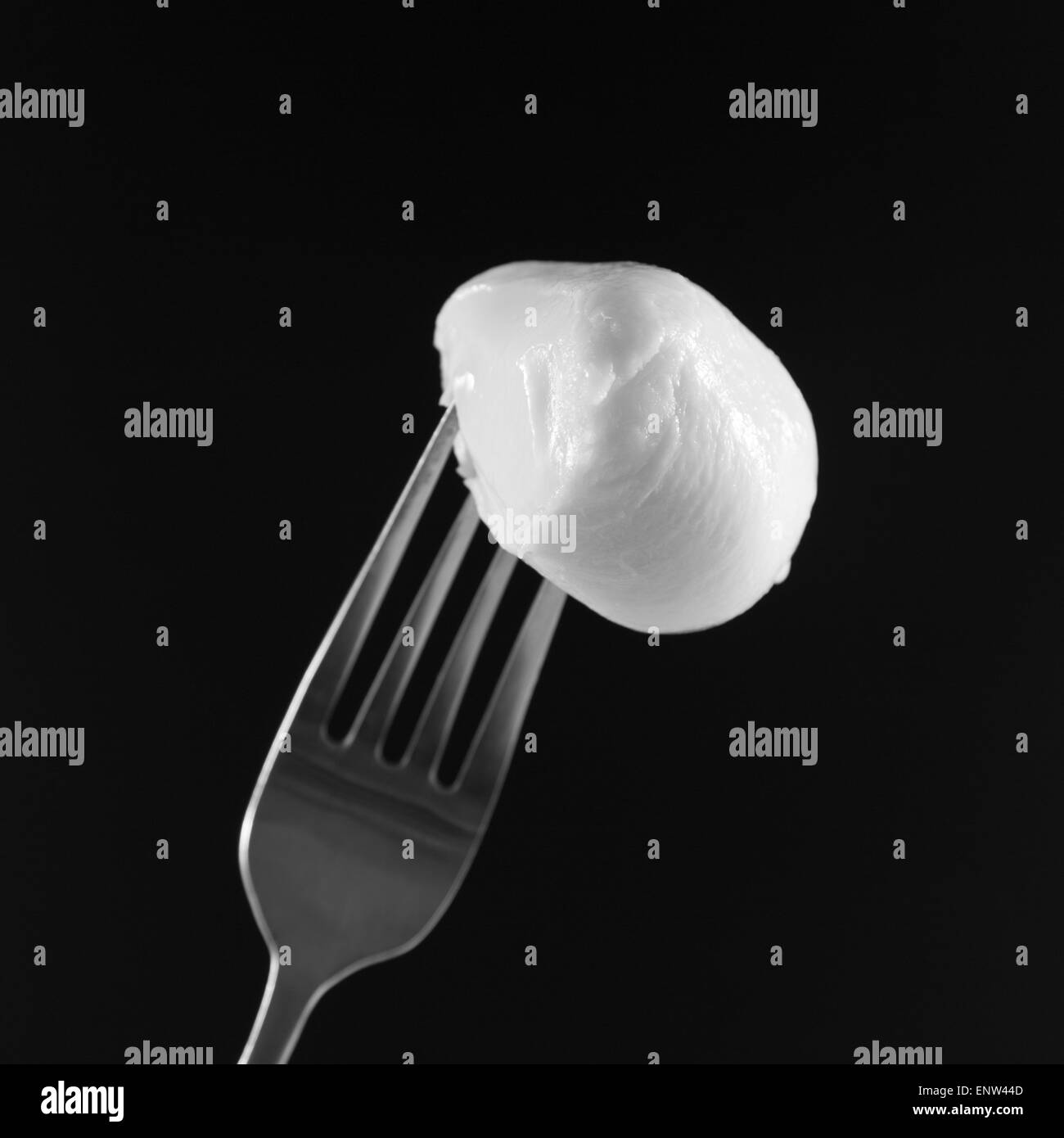 Delicious morsel of mozzarella on a black background Stock Photo - Alamy
