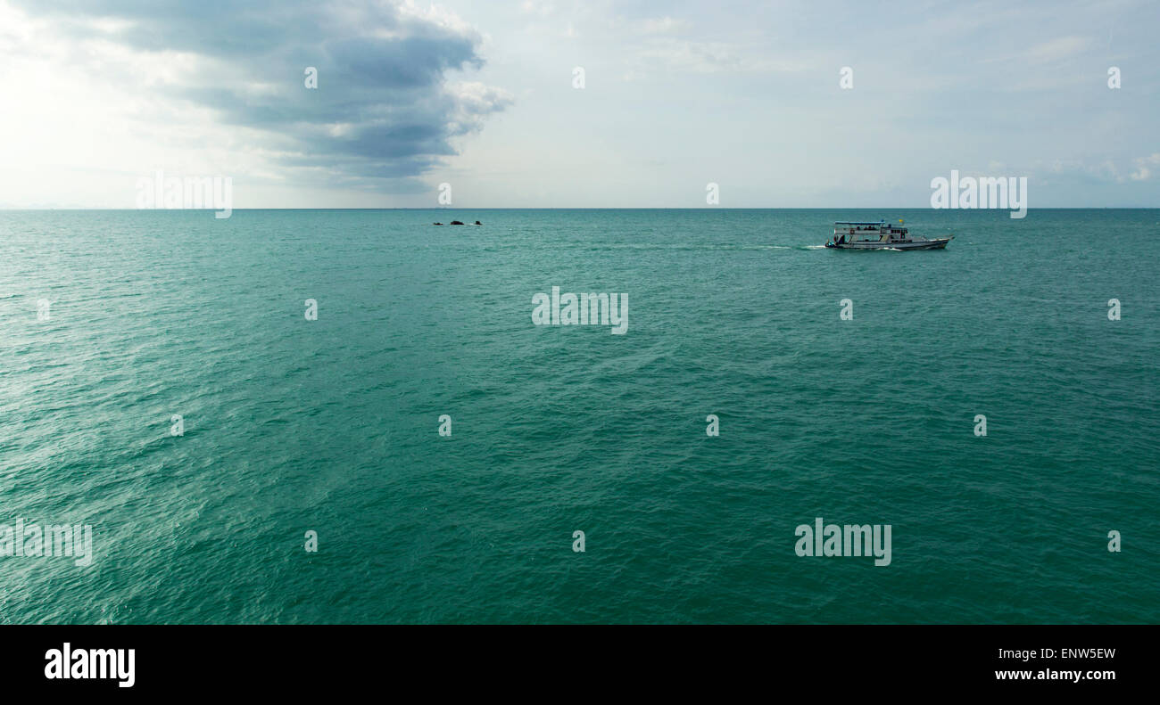 view of quiet ocean before the storm and single boat. profession risk ...