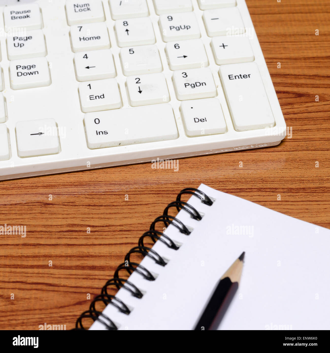 keyboard computer with notebook and pencil Stock Photo - Alamy
