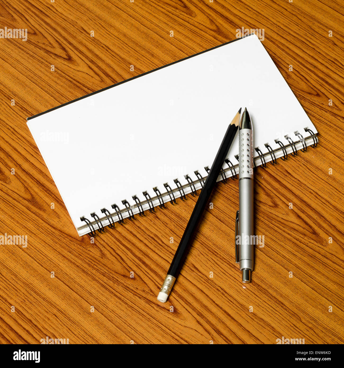 notebook pen and pencil on wood background Stock Photo - Alamy