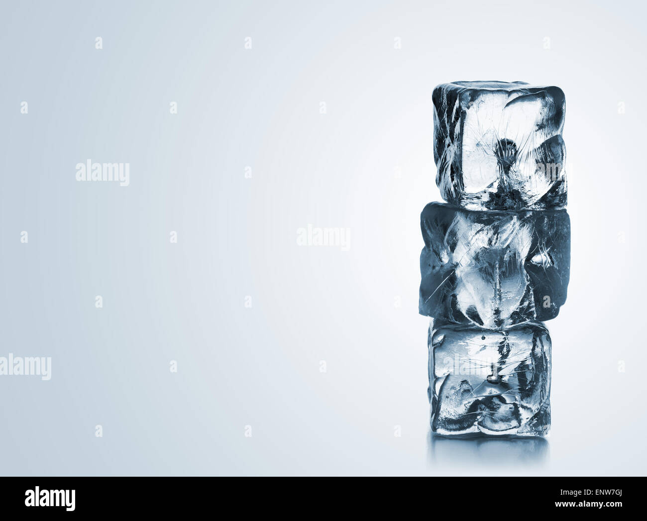 Three ice cubes stacked over blue gradient background with copy space ...
