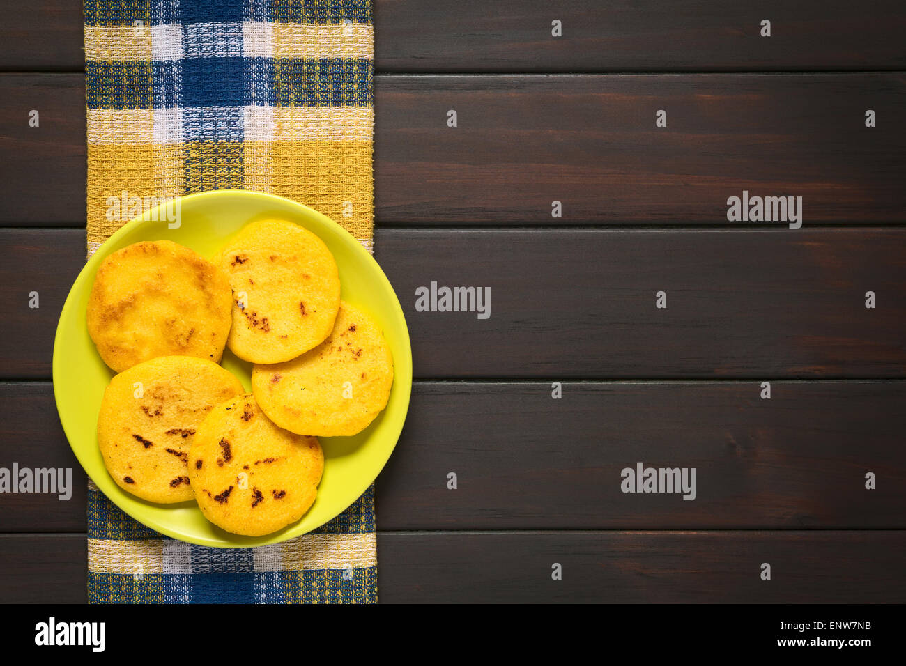 Plate of arepas photographed on dark wood with natural light. Arepas ...