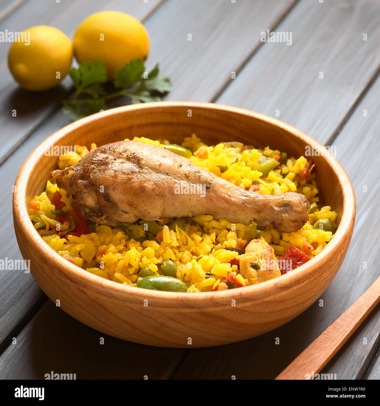 Wooden bowl of chicken paella, a traditional Valencian (Spanish) rice ...