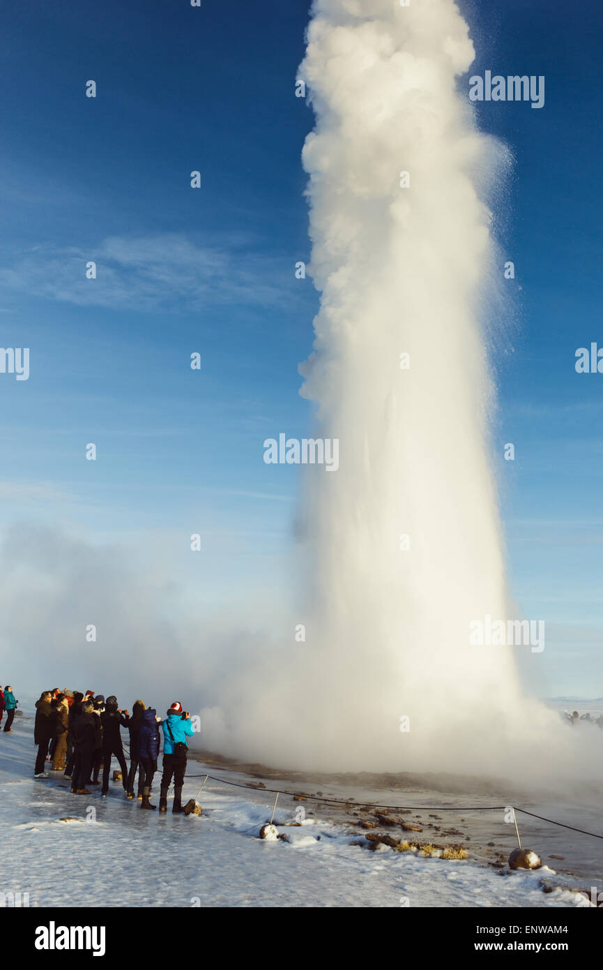 Tourists taking photos of a water spout at Geyser, Iceland Stock Photo ...