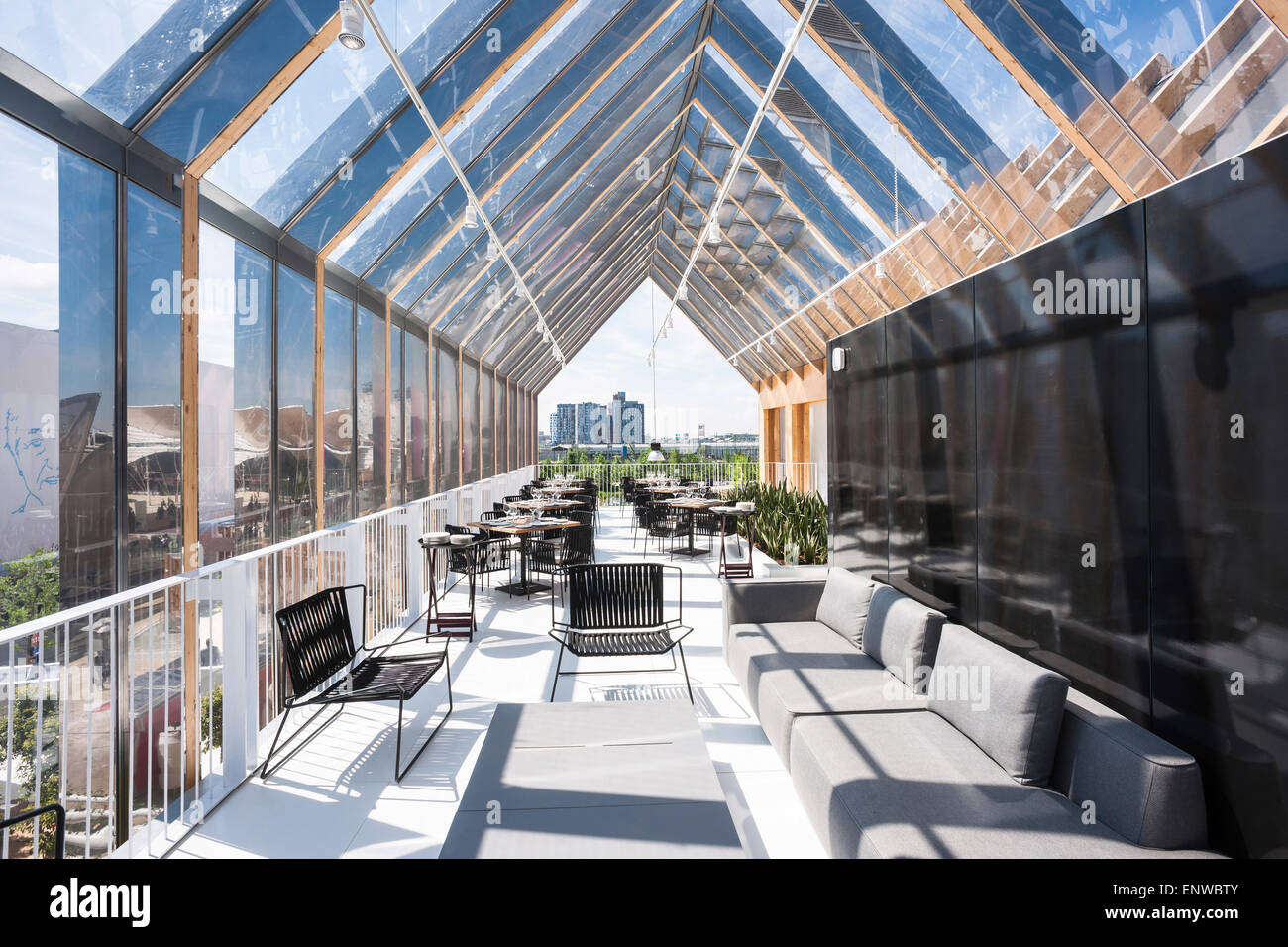 Glazed upper floor balcony with cityscape beyond. Milan EXPO 2015 ...