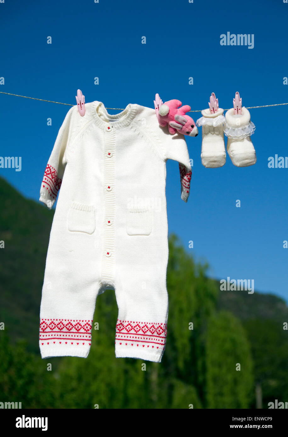 baby clothes in blue sky Stock Photo - Alamy