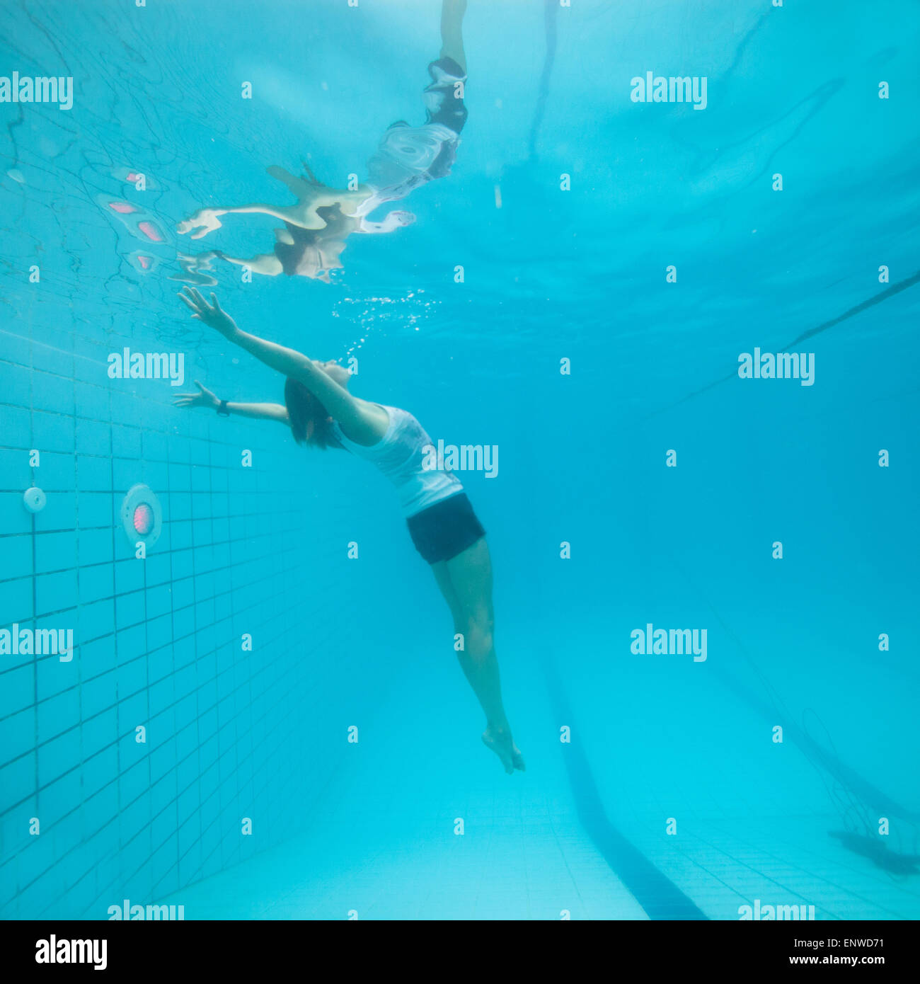 Woman freediving underwater in a pool Stock Photo - Alamy