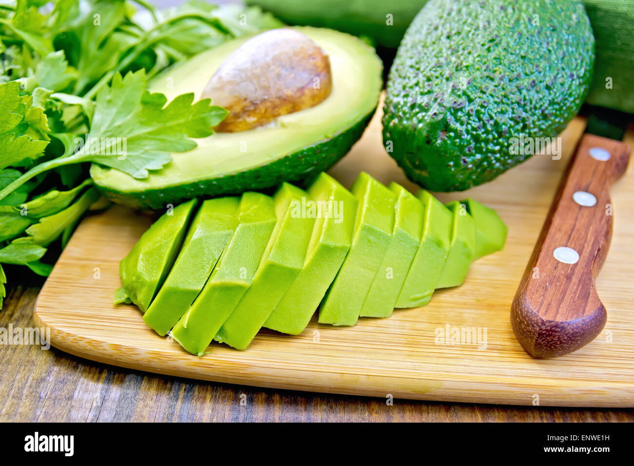 Avocado slices on board with knife Stock Photo - Alamy