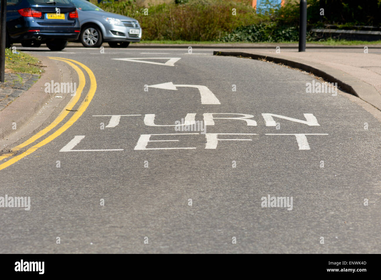 Turn Left painted sign on road with direction arrow Stock Photo - Alamy