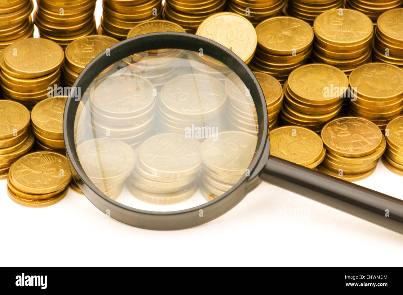 Stack of coins and magnifying glass on the white Stock Photo - Alamy